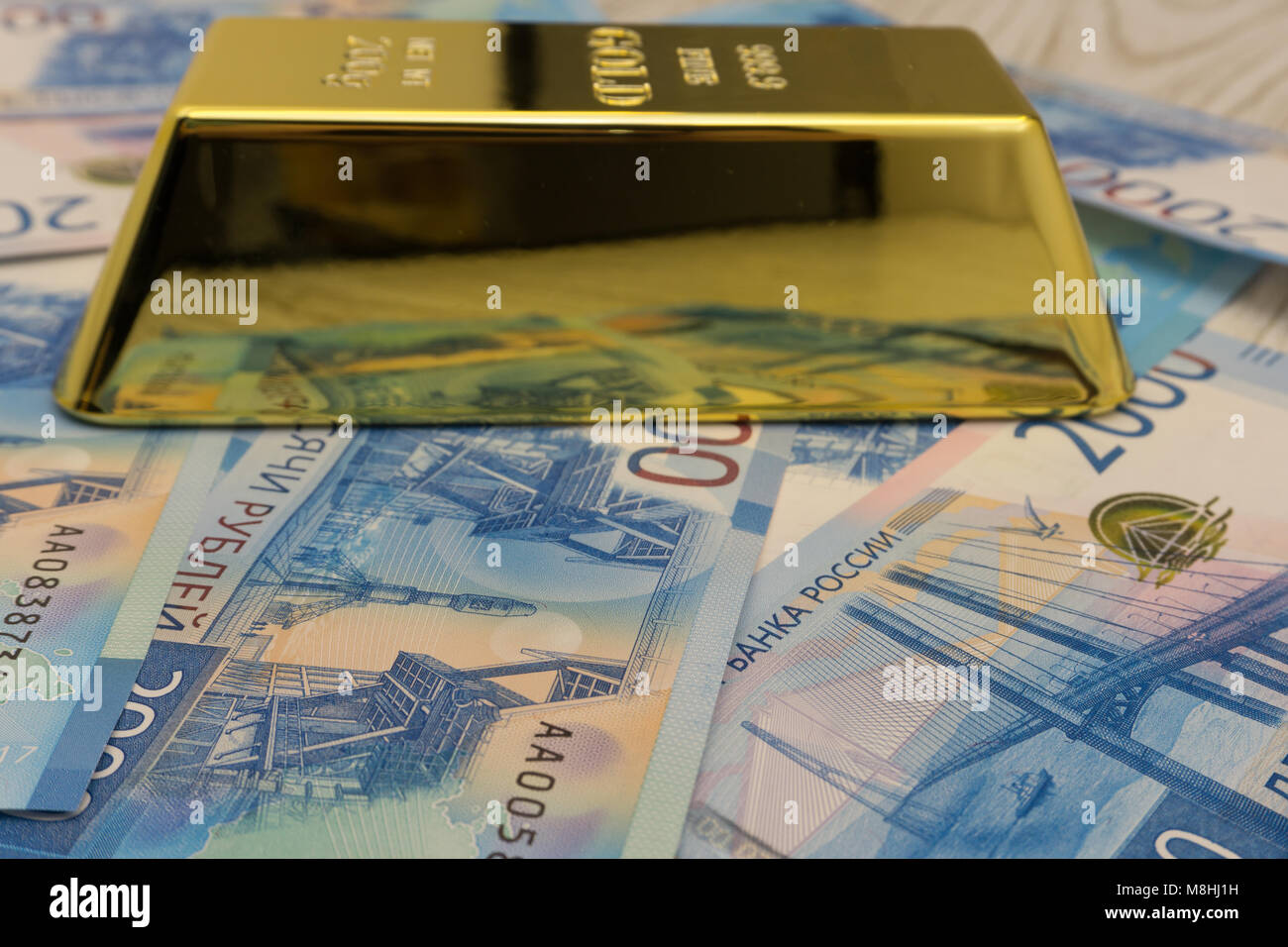 banknote and gold bullion isolated on black Stock Photo - Alamy