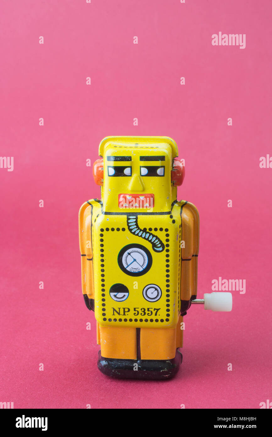 Little mechanical yellow toy robot Stock Photo - Alamy