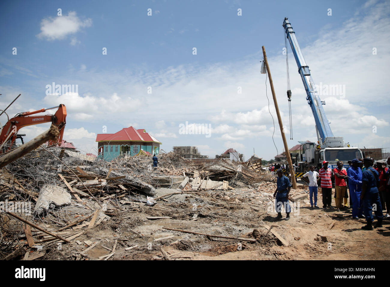 Bujumbura, Burundi. 17th Mar, 2018. People stand next to debris of a ...