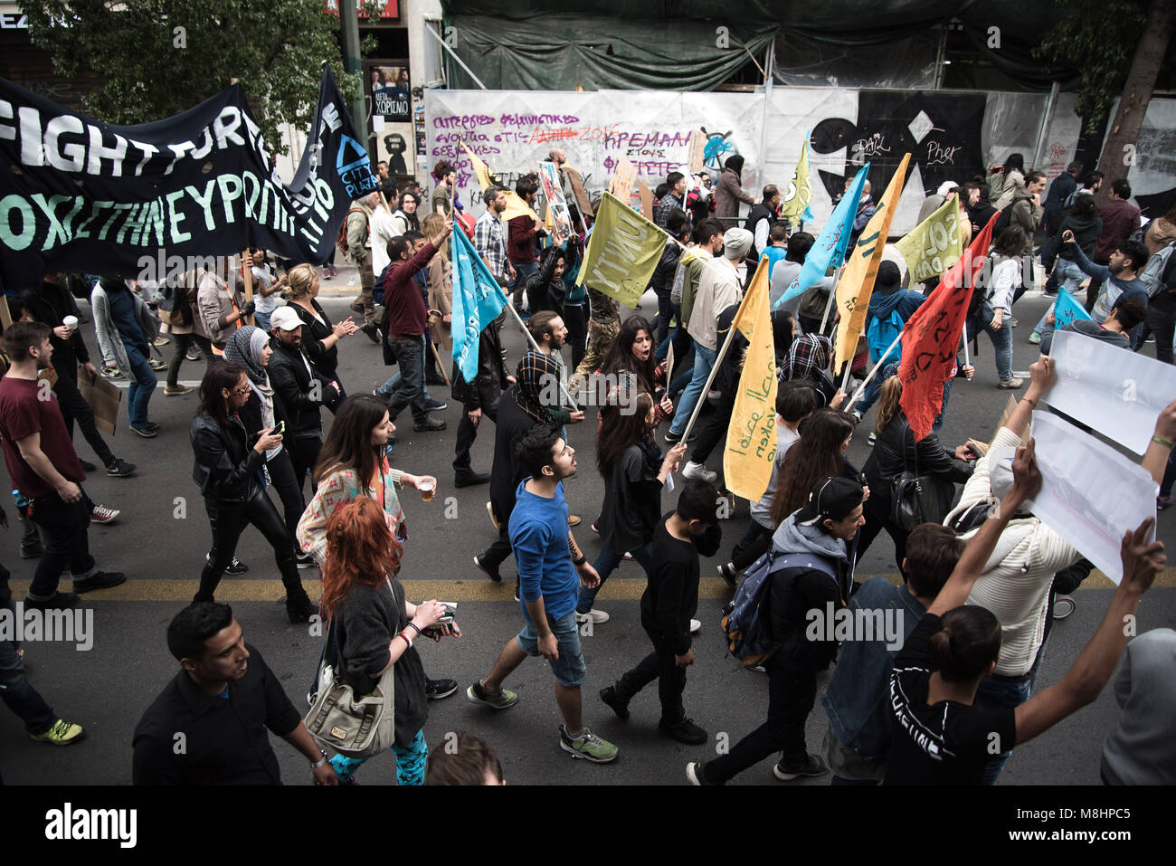 Athens, Greece. 17th Mar, 2018. Protesters hold placards and flags and ...