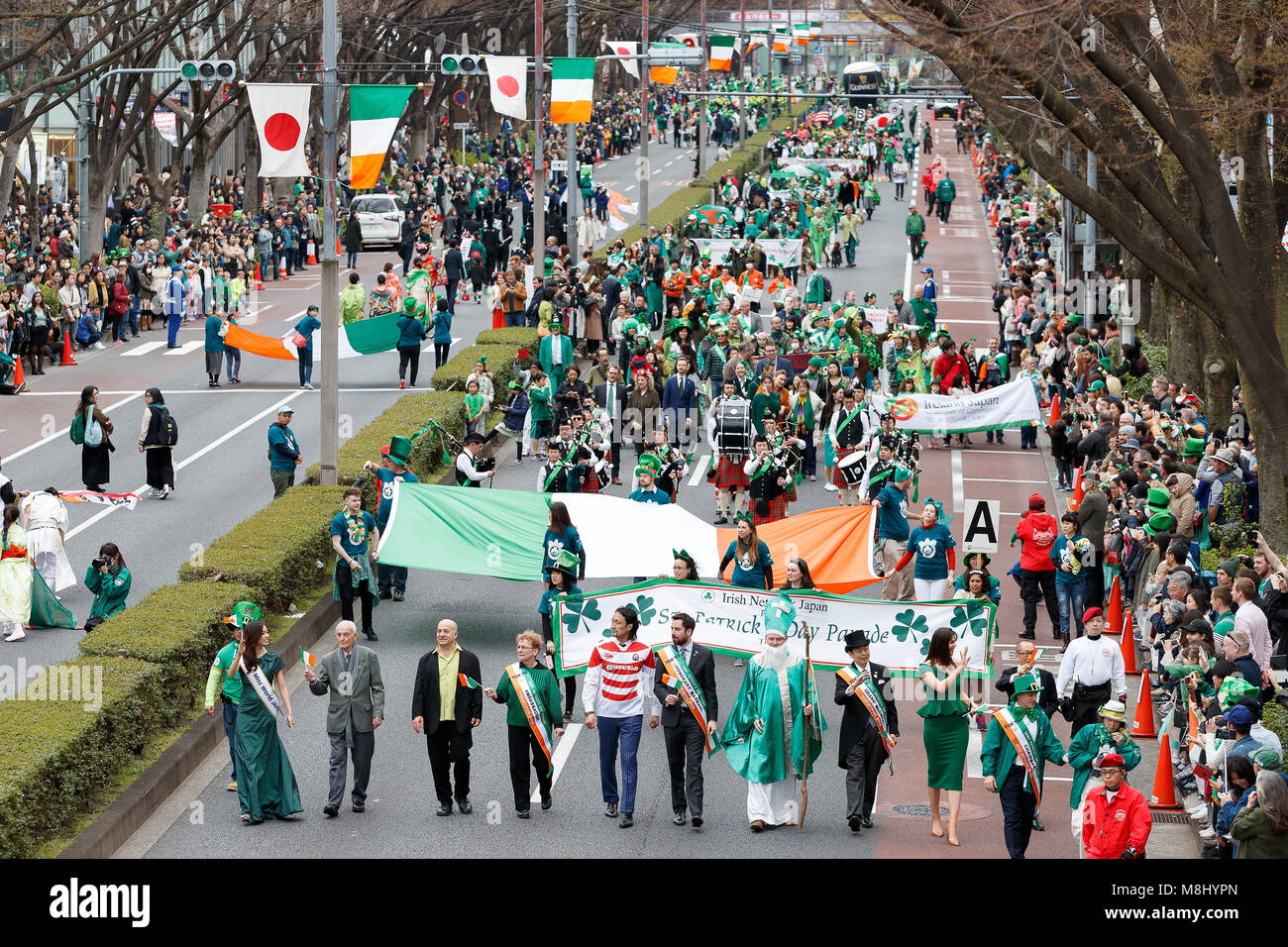 Tokyo, Japan. 18th March 2018. Participants dressing green march during ...