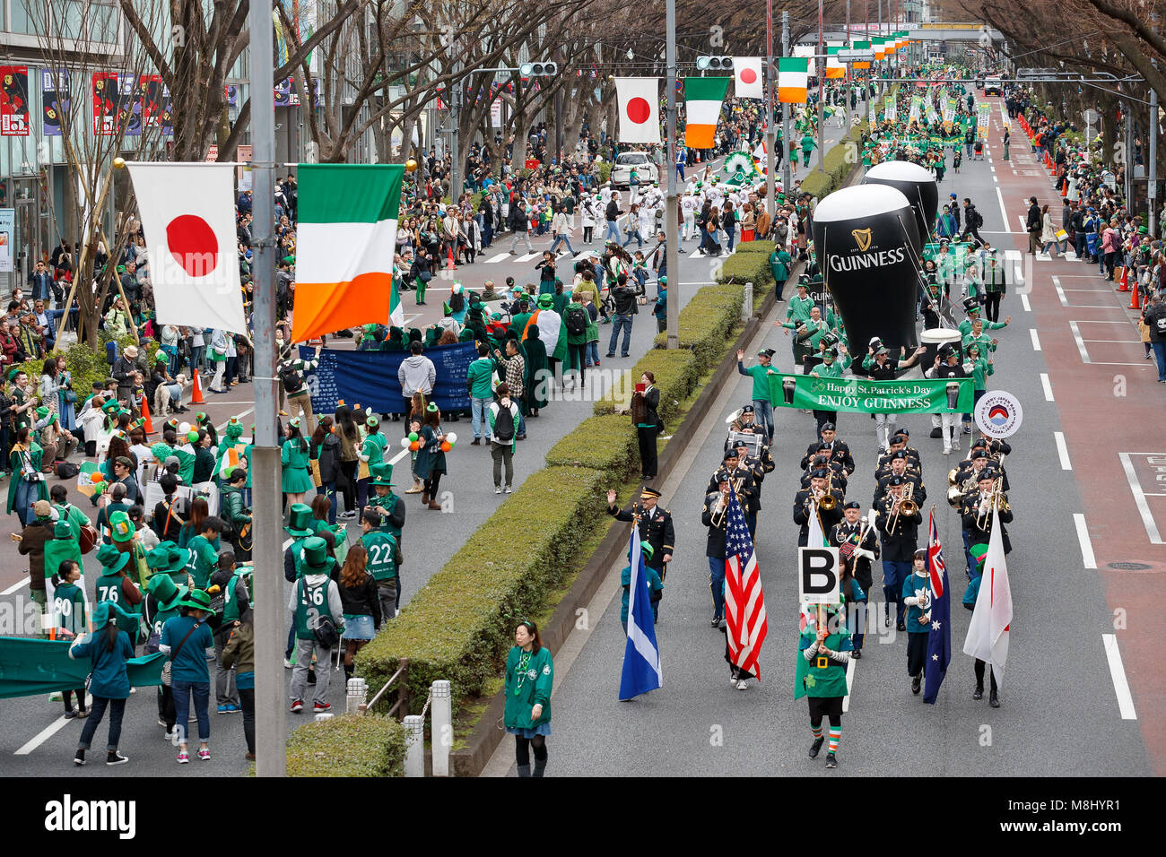 Tokyo, Japan. 18th March 2018. Participants dressing green march during ...