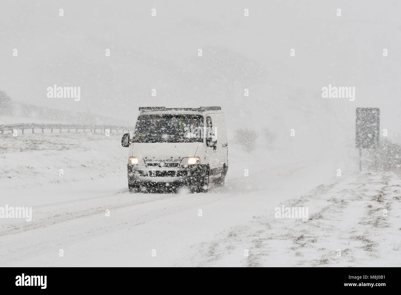 Long Bredy, Dorset, UK. 18th March 2018. UK Weather. A van struggles ...