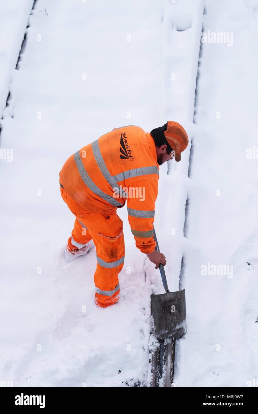 Network Rail rail maintenance staff clear snow from rail tracks and ice ...