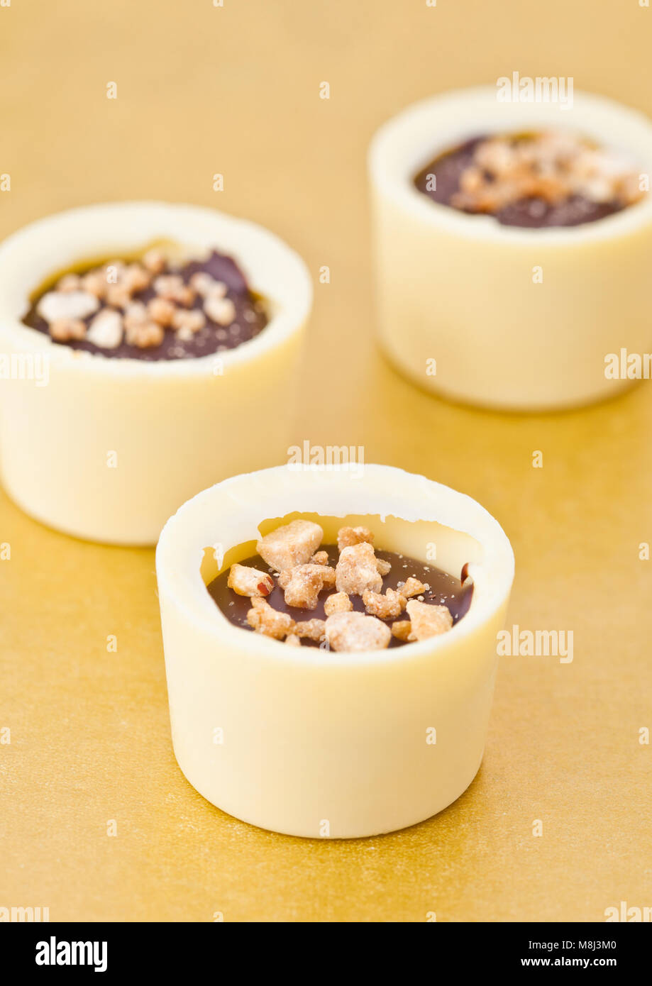 Assortment of luxury white chocolate candies variety on a golden ...