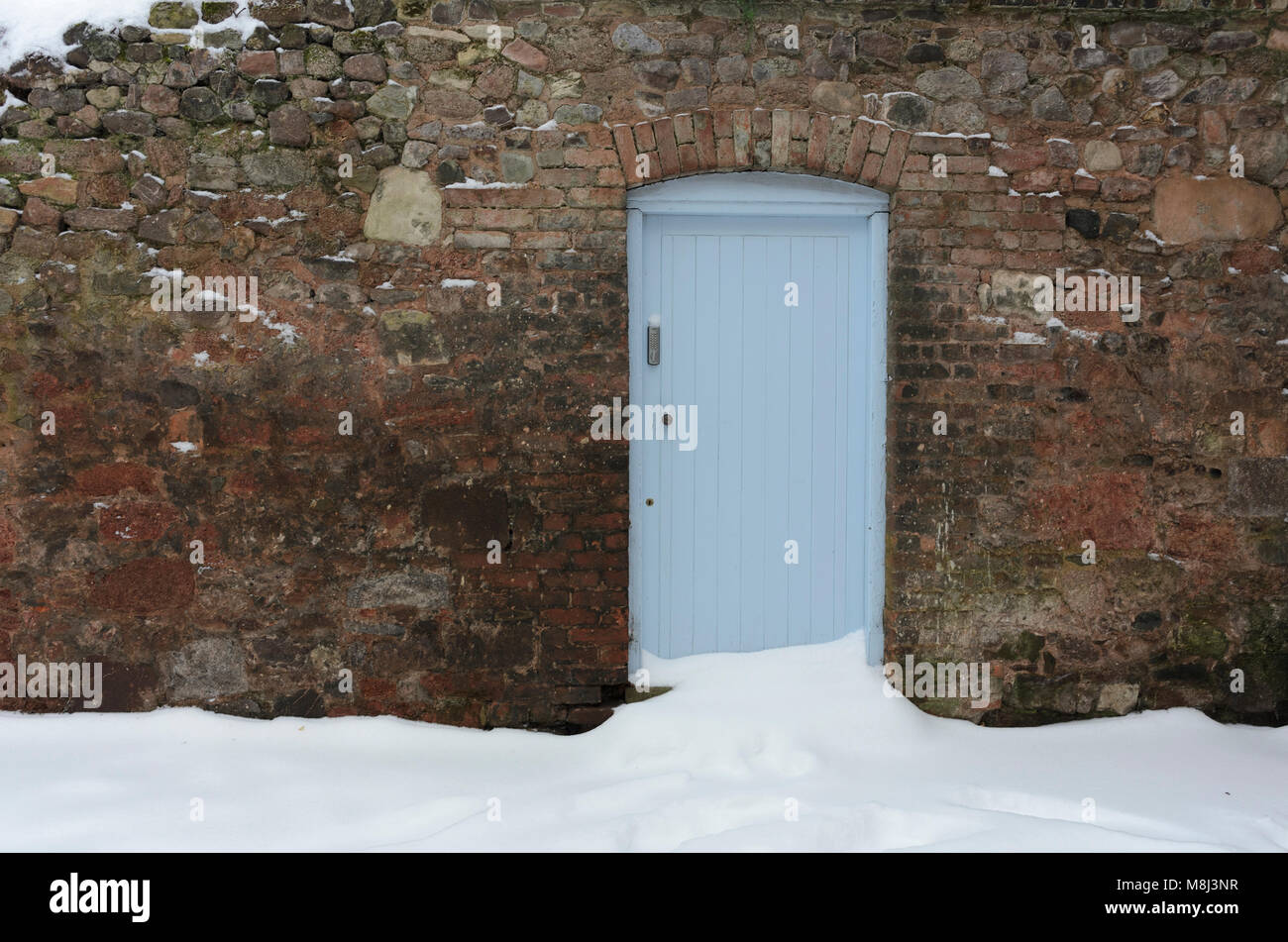 Blue door in snow Stock Photo - Alamy