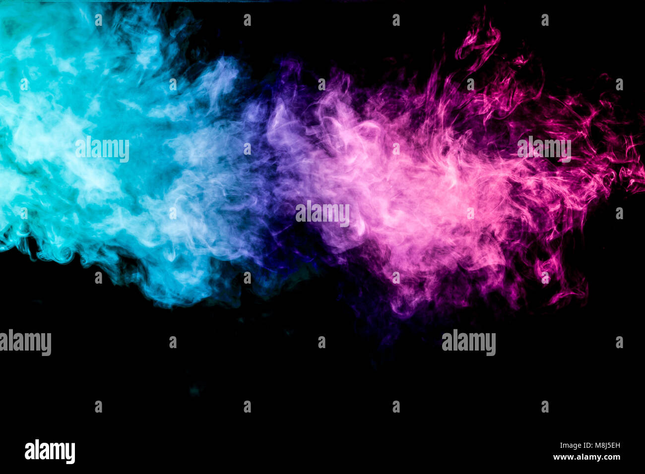 Colorful smoke of pink and blue on a black isolated background ...