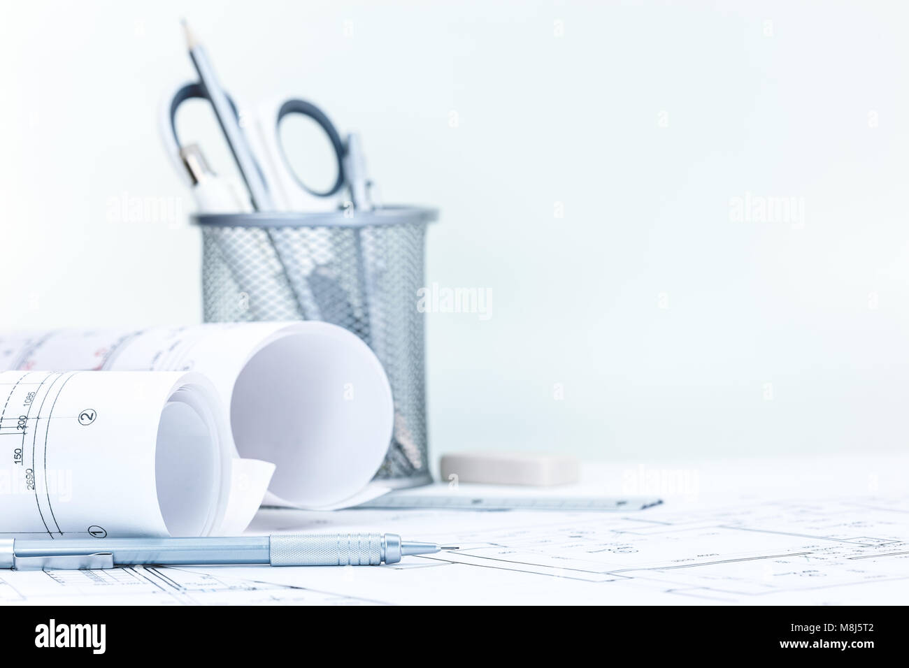 engineering project plan with blueprint rolls, pencil, stationary set ...