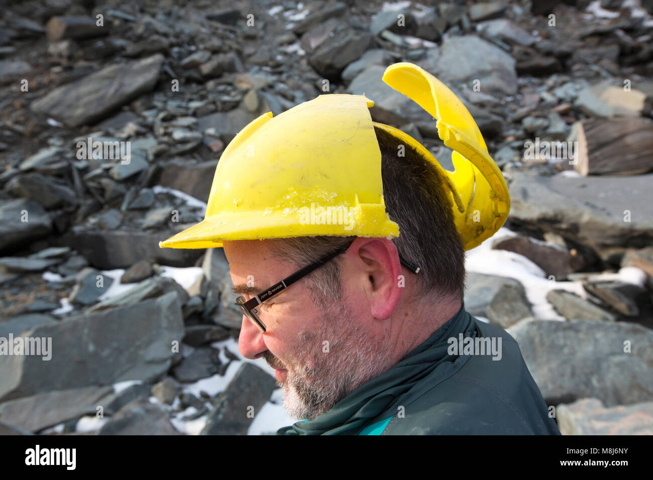 A man wearing a shattered hard hat Stock Photo - Alamy