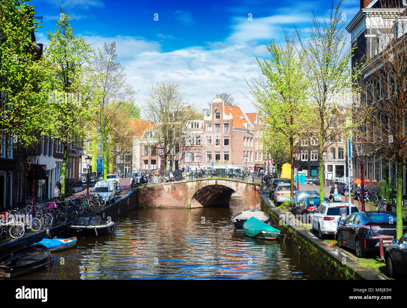 Facades of dutch historical houses and bridge over canal, Amsterdam ...