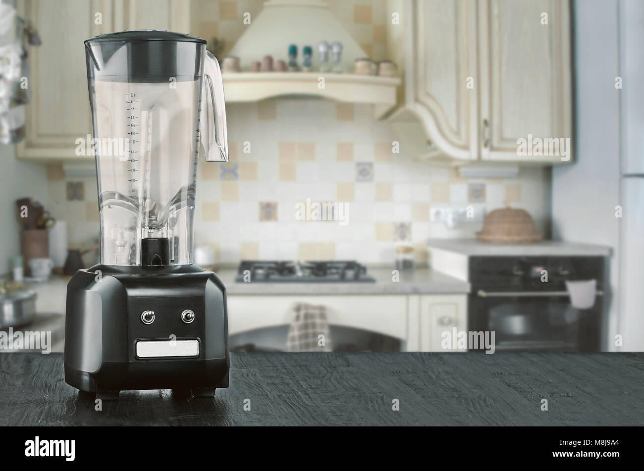 Blender and wooden table in kitchen Stock Photo - Alamy