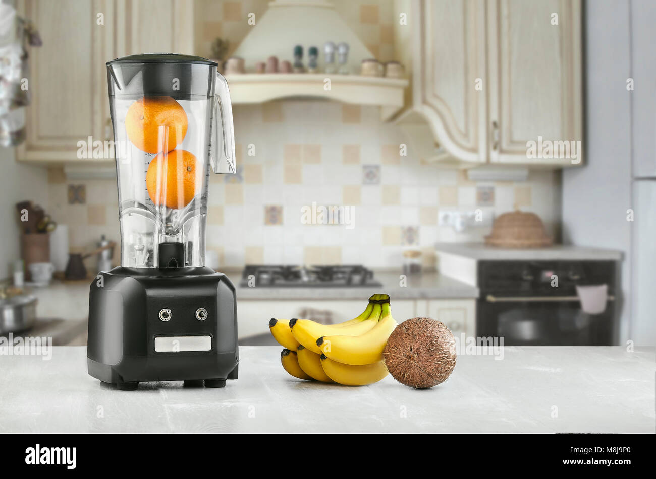 Metal food blender close-up with fresh exotic tropic fruits next to it ...