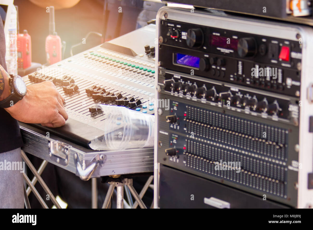 DJ are using their hands to adjust the volume and test the sound to the ...