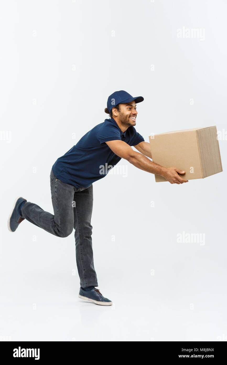 Delivery Concept - Handsome African American delivery man rush running ...