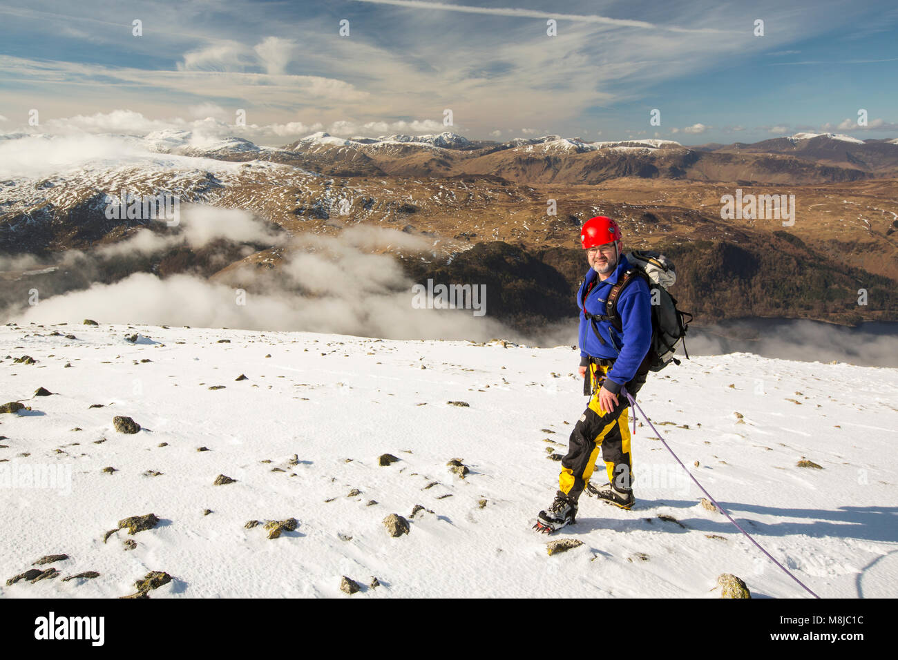 A climber just having summited a winter climb on Helvellyn, Lake ...