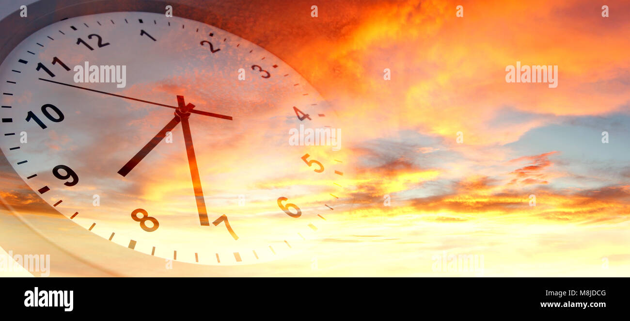 Clock face in bright sky. Time passing Stock Photo - Alamy