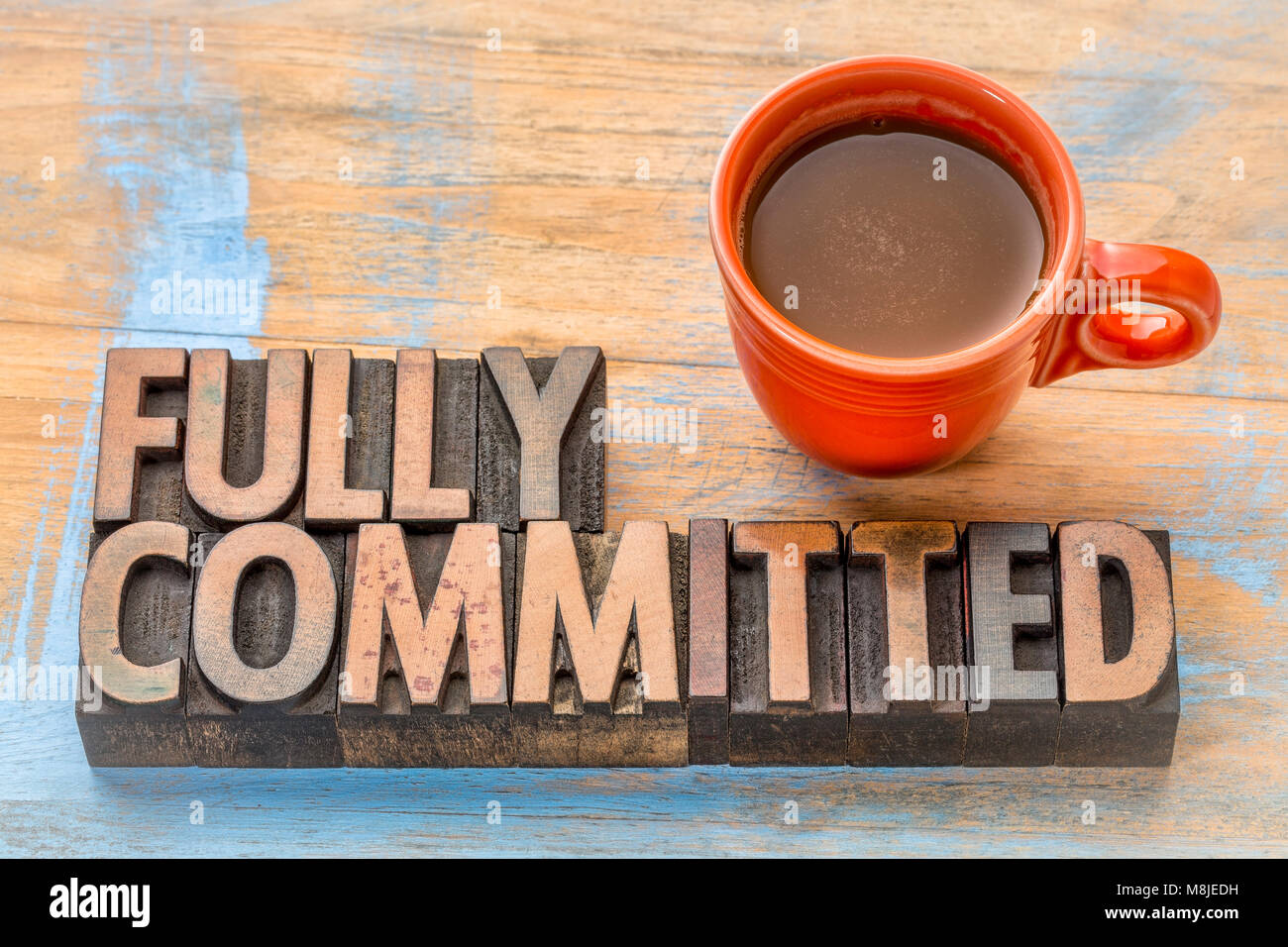 fully commited - word abstract in vintage letterpress wood type with a ...