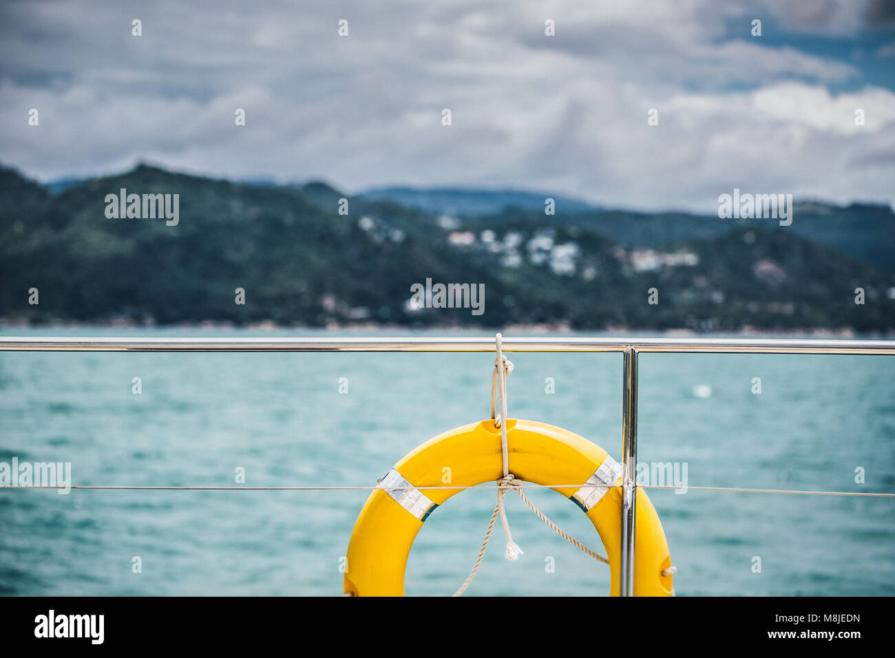Close-up Yellow life ring hanging on boat with ocean background Stock ...