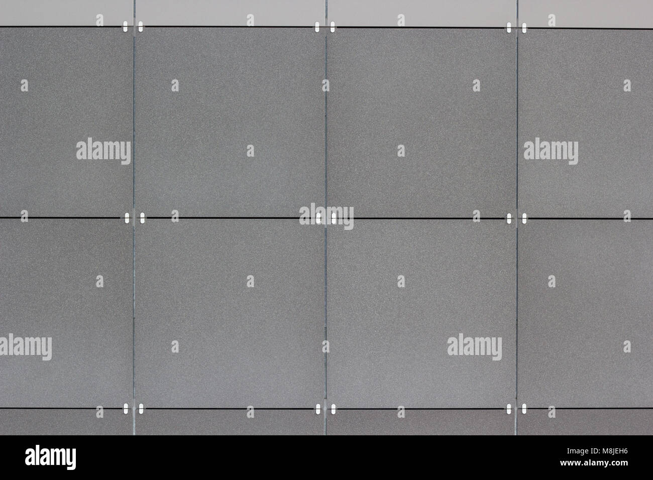 Brushed metal tiled panels at the wall Stock Photo - Alamy