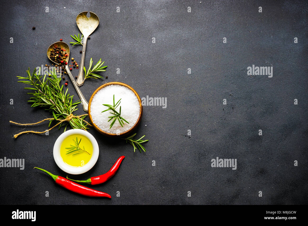 Organic food cooking concept with fresh spices on dark background with ...