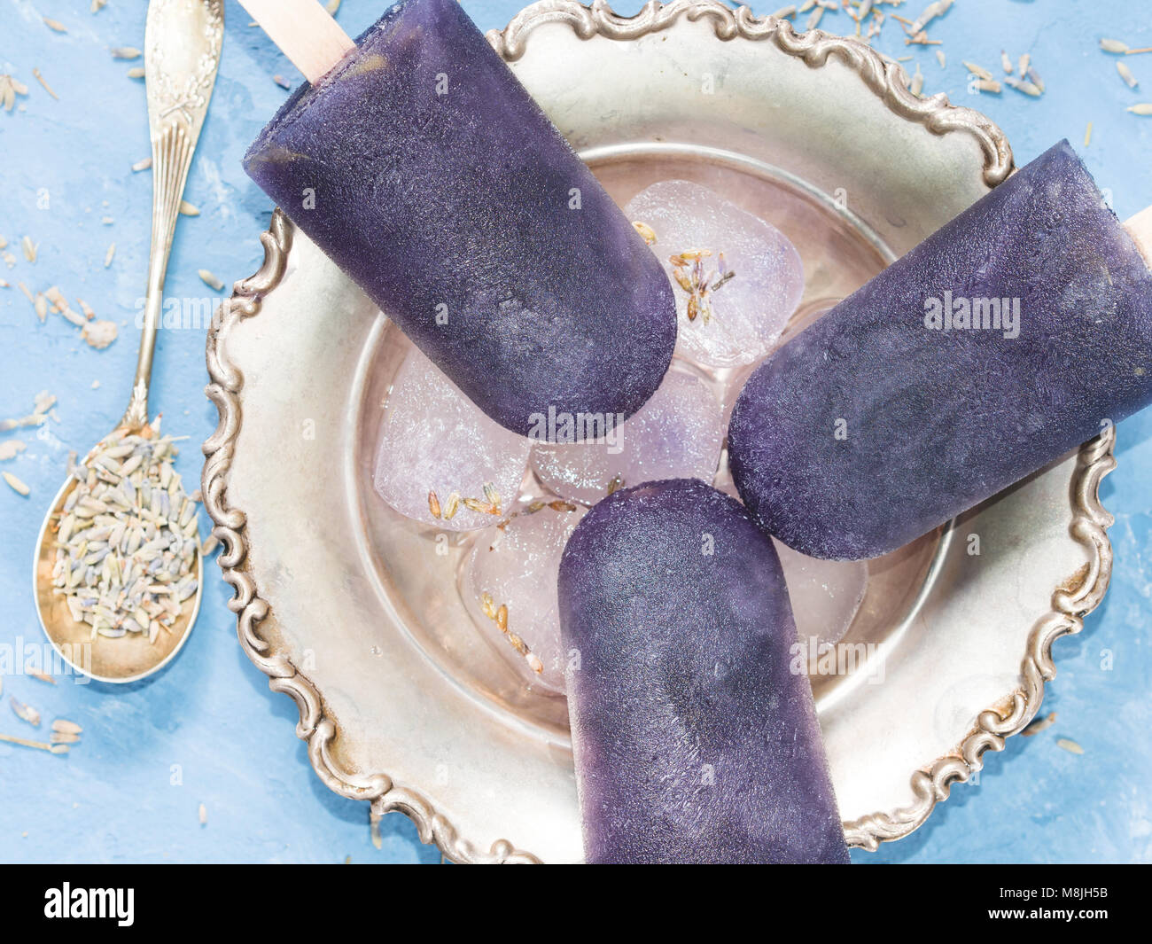 Lavender popsicles made of frozen orange and lemon juice with syrup in ...