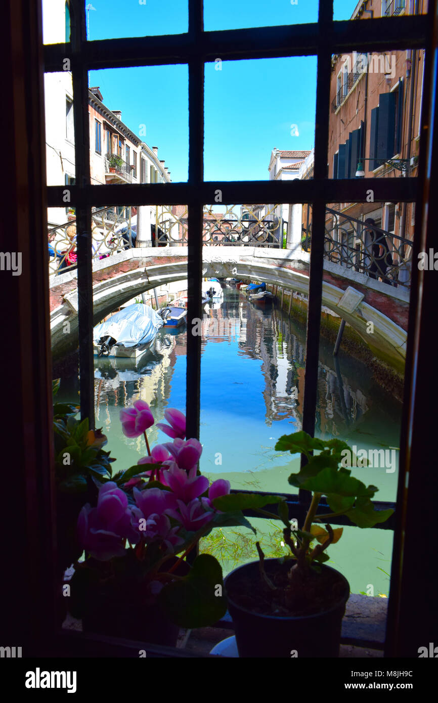 View from a cafe table through a window of a Venetian Bridge, Venice ...