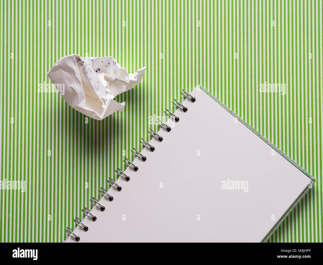 Open notebook and rumpled paper page on green background. Inspiration ...