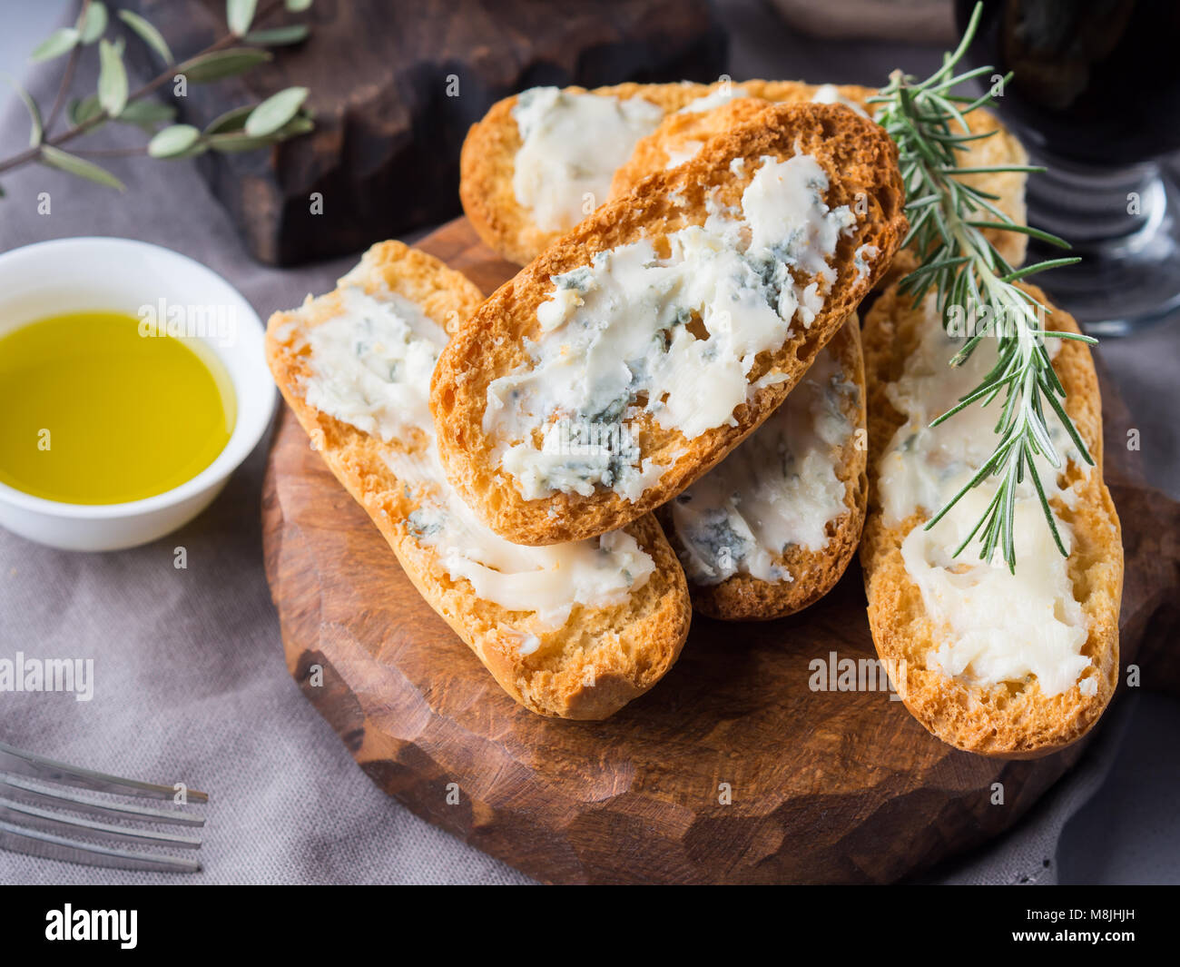 Italian toasts with gorgonzola cheese on rustic background with wine ...