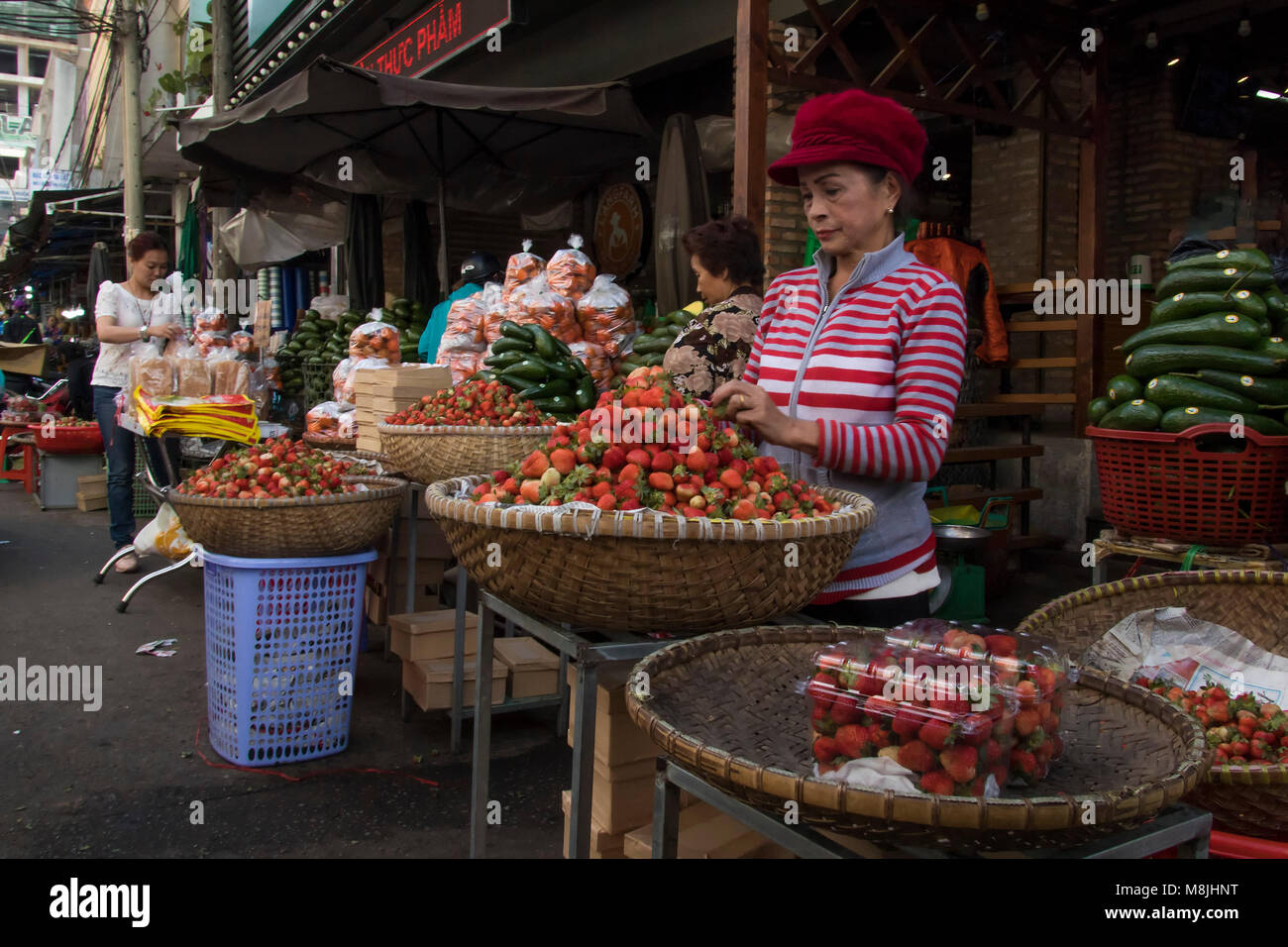 Woman tending to her Market Stall Stock Photo - Alamy