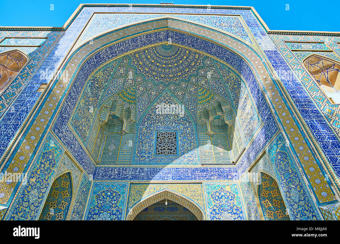 The portal (iwan) of Chaharbagh madraseh with complex tiled patterns in ...