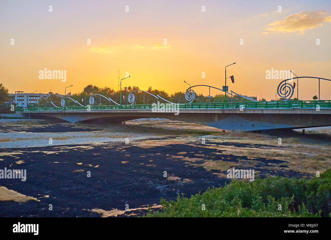 The beautiful sunset sky over the modern Ferdowsi bridge, decorated ...