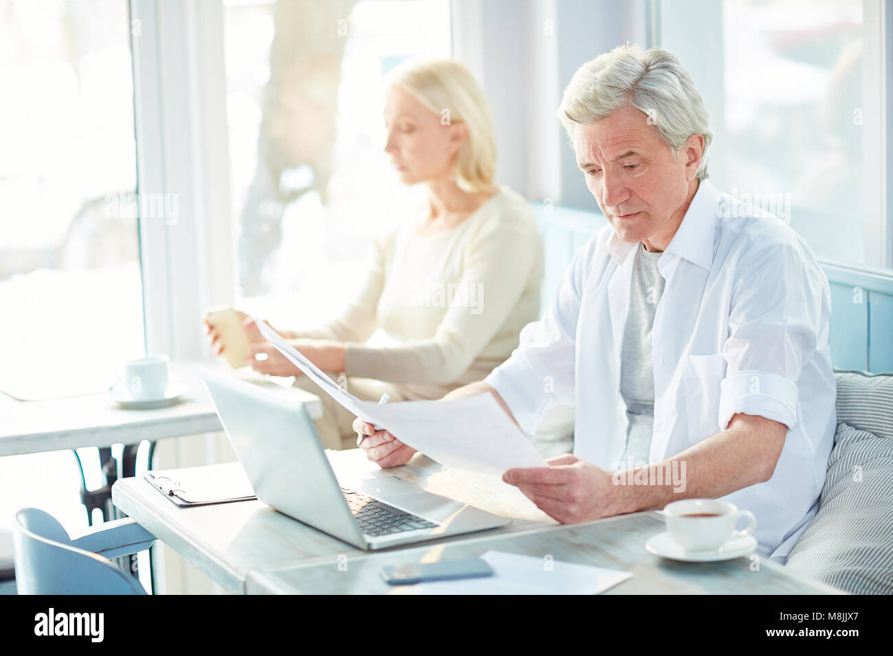 Man working with papers Stock Photo - Alamy