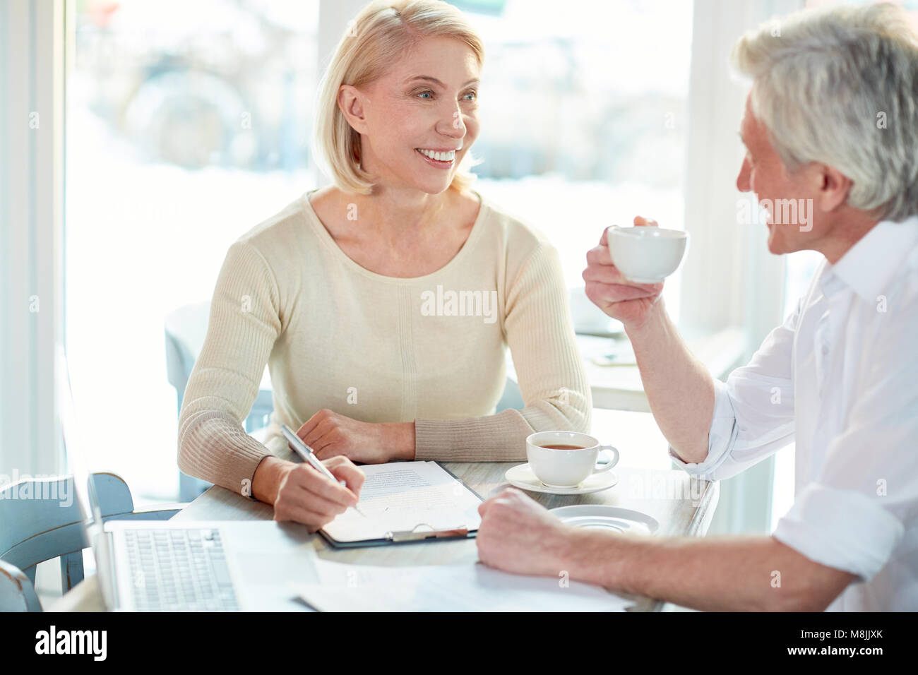 Having tea and working Stock Photo - Alamy