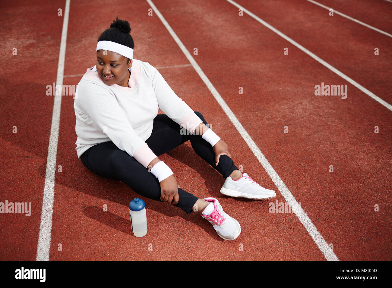 Woman on race track Stock Photo - Alamy