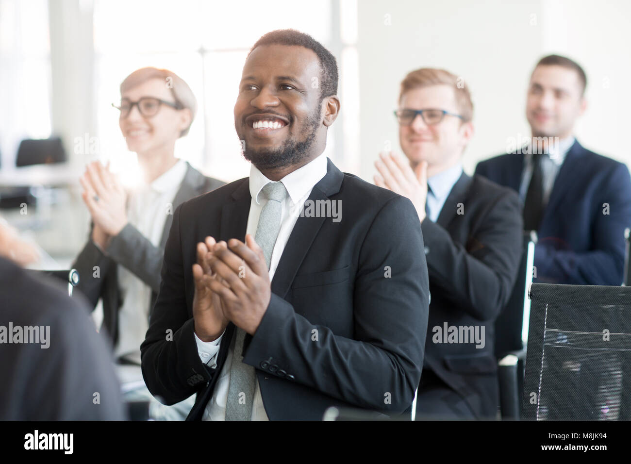 Applauding speaker group happy hi-res stock photography and images - Alamy
