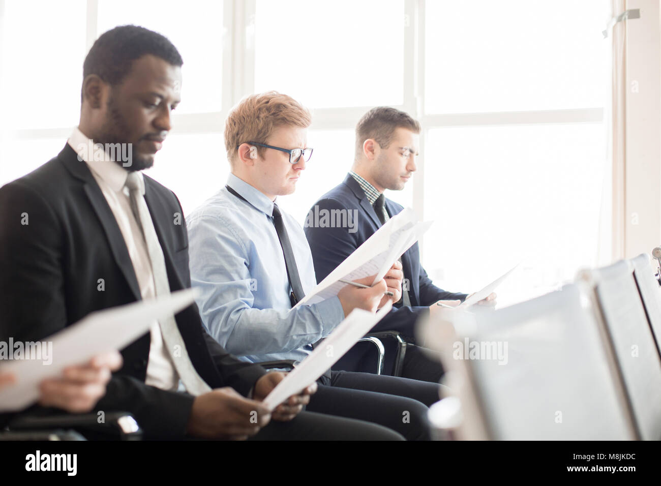 Men reading papers Stock Photo - Alamy