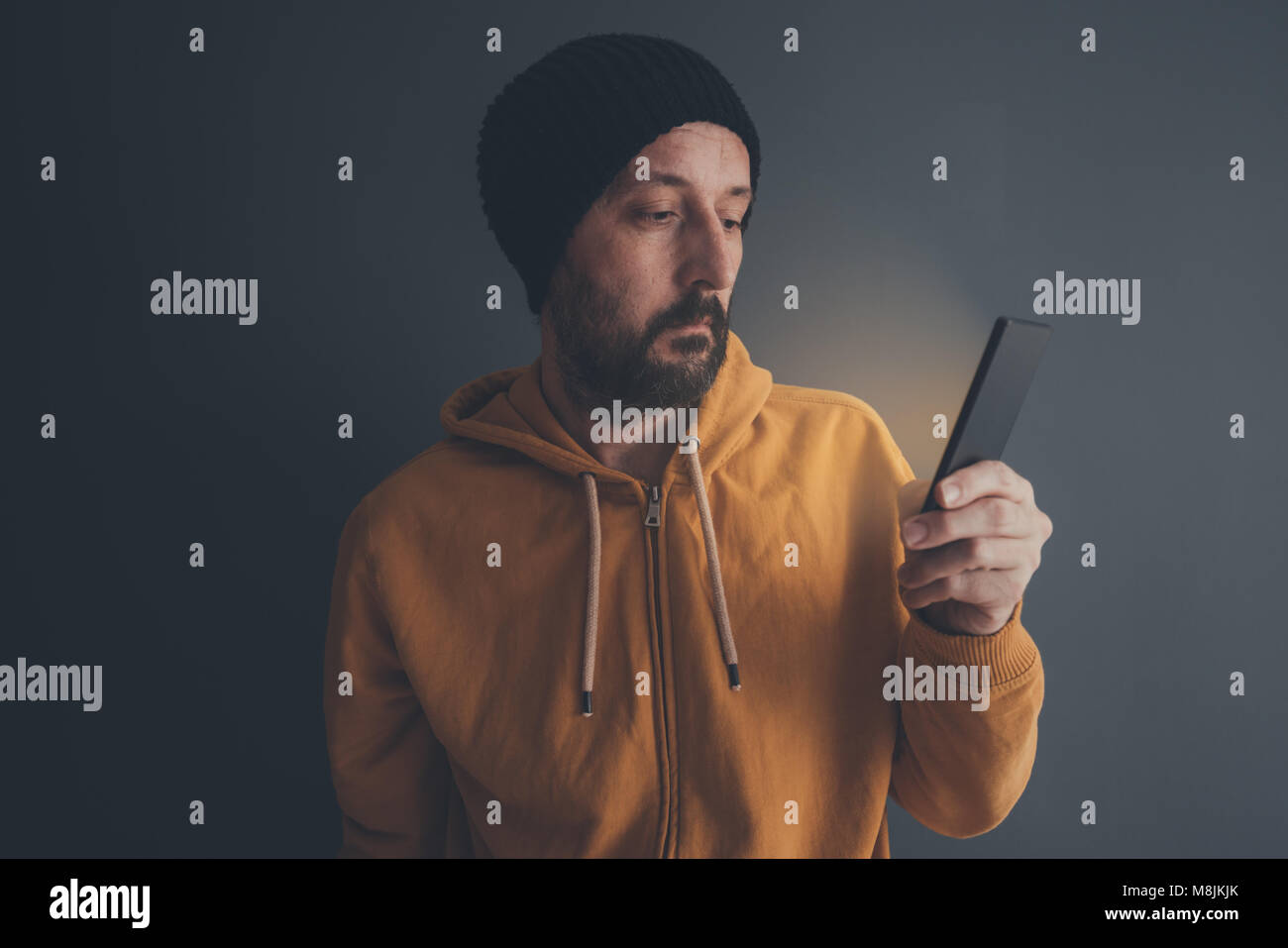 Man looking at his smartphone screen, casual male person using mobile ...