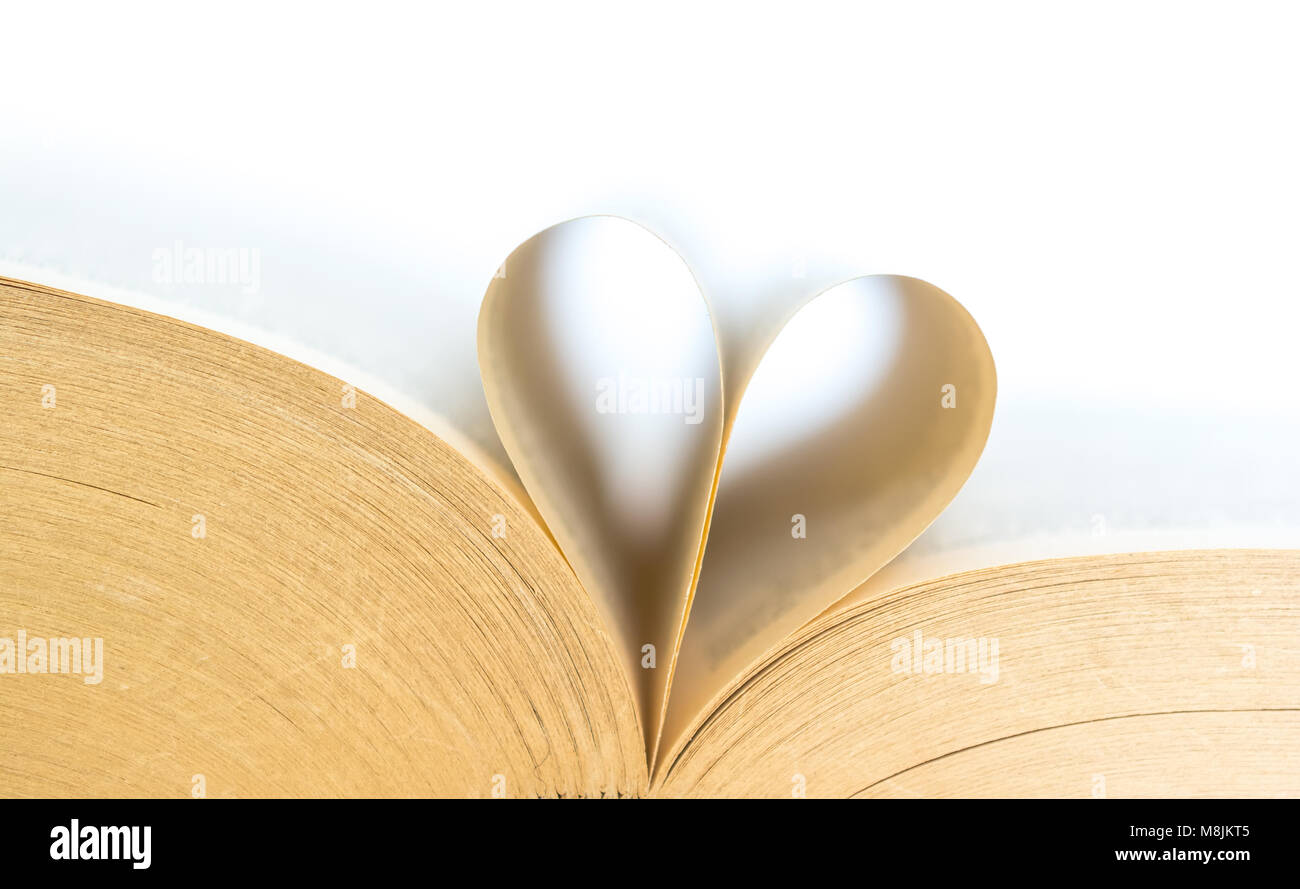 Book with opened pages of shape of heart isolated on white background ...