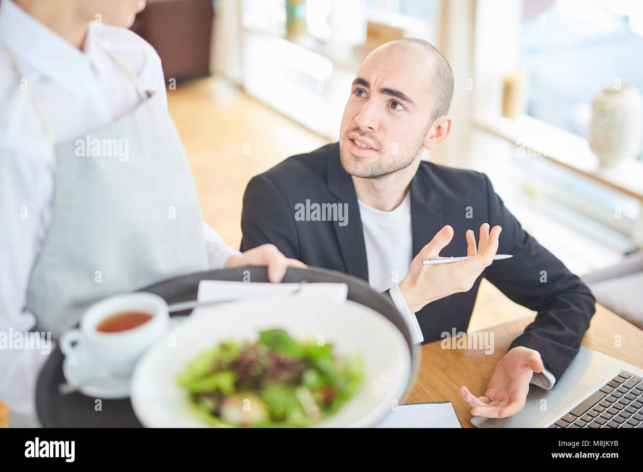 Man doing the ordering Stock Photo - Alamy