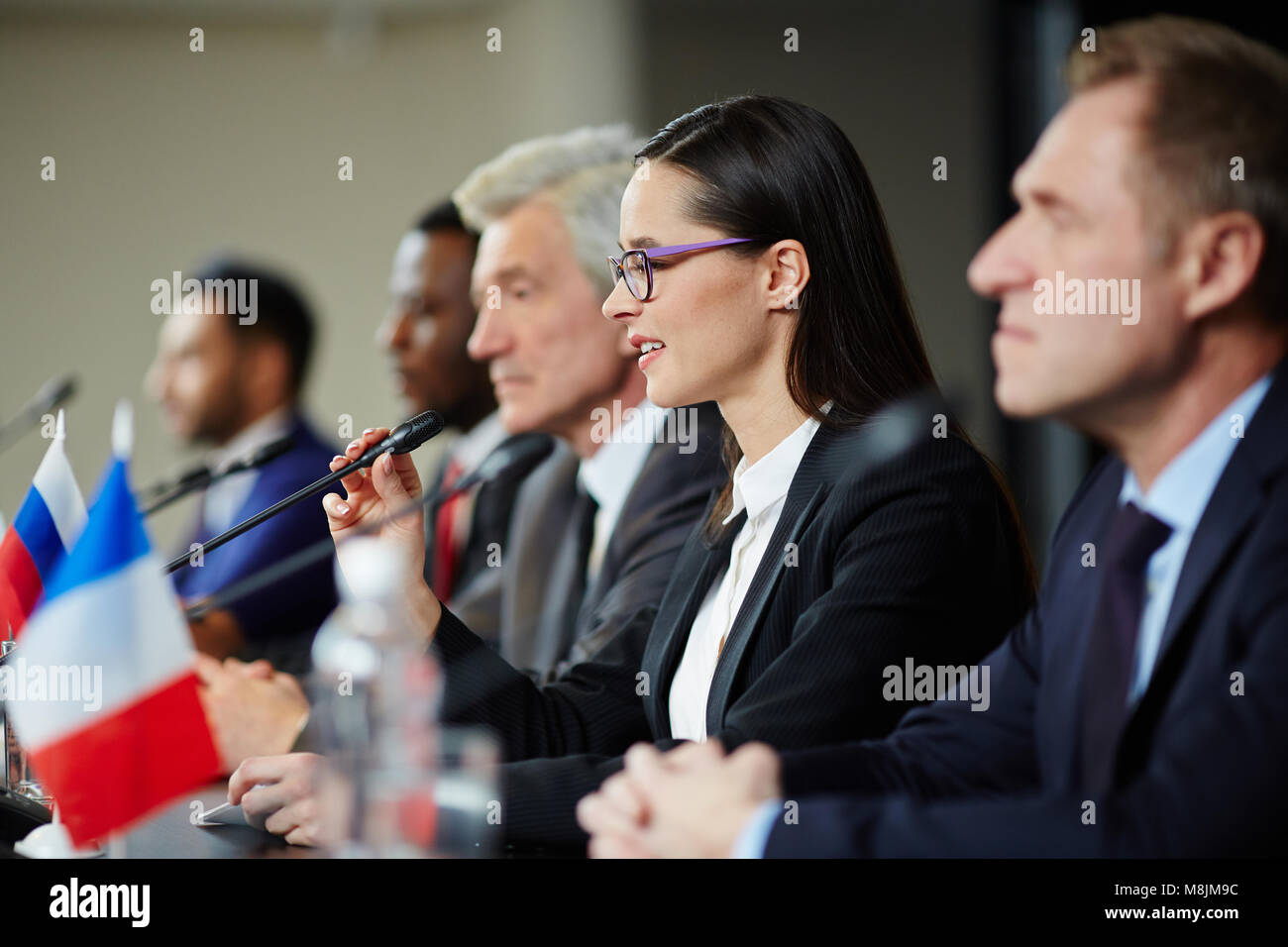 Female professional explaining colleagues hi-res stock photography and ...