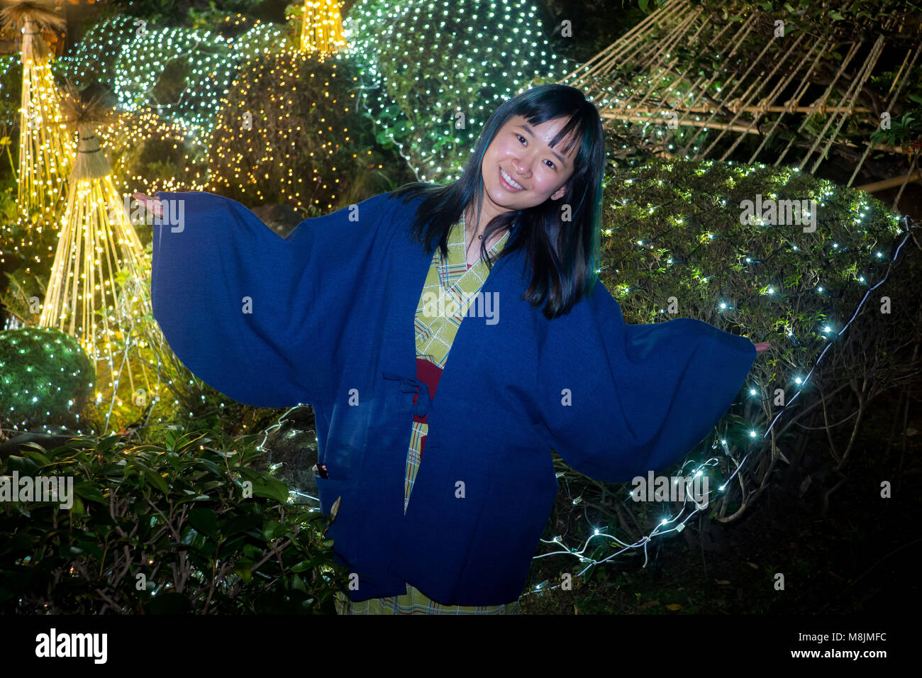 Beautiful young woman in a Yukata posing in a japanese garden that is ...