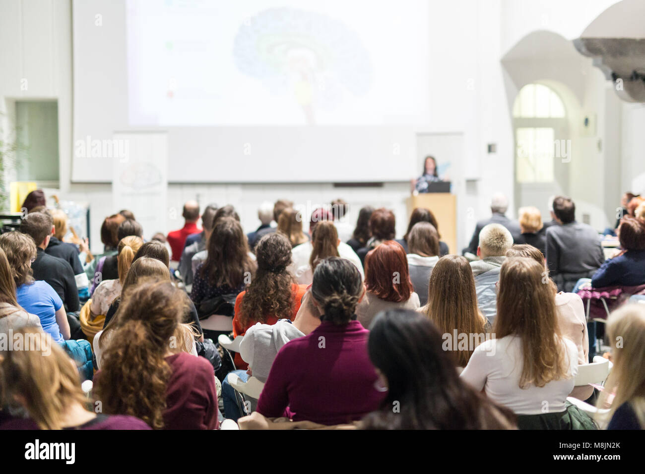 Woman giving presentation in lecture hall at university Stock Photo - Alamy