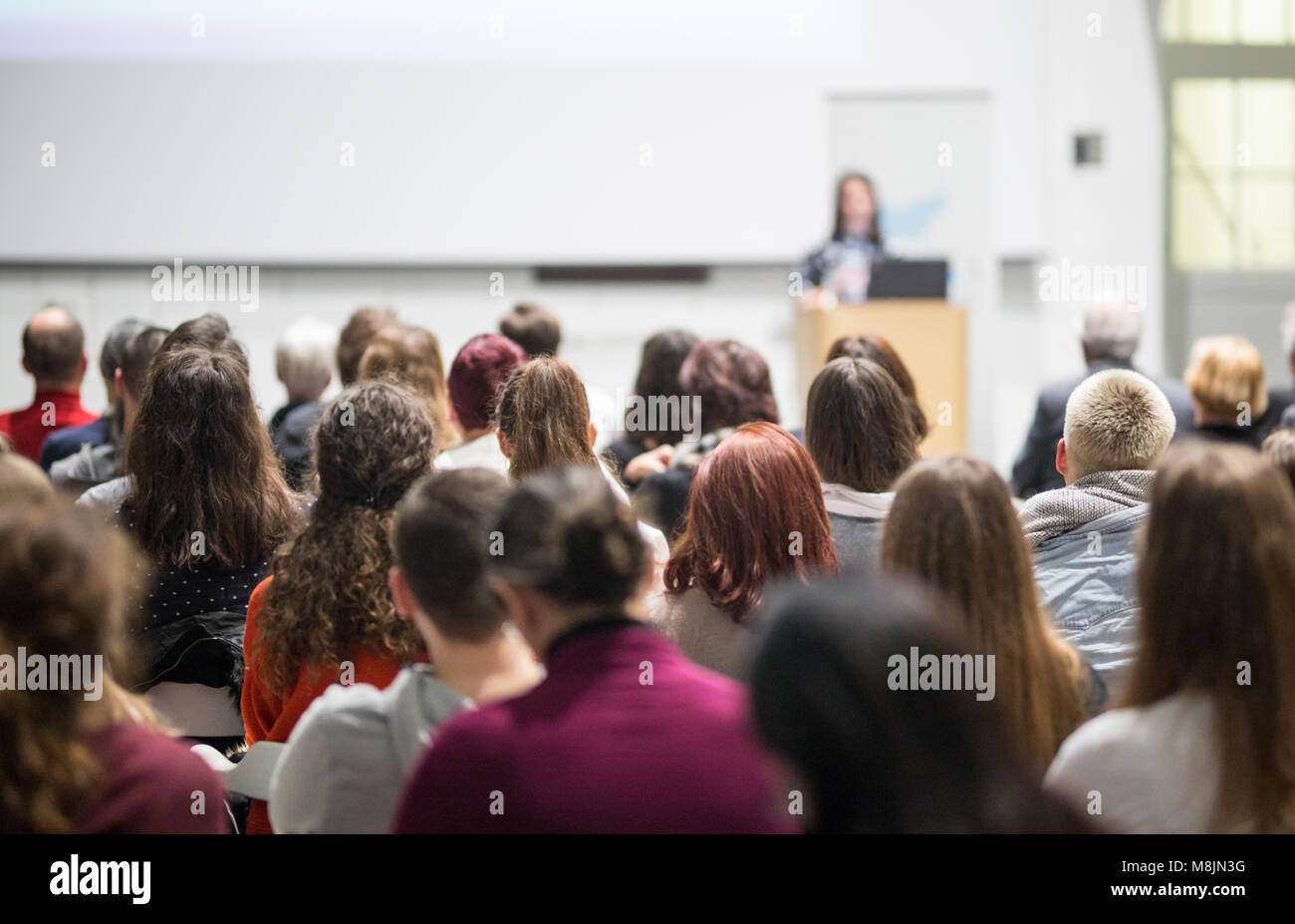 Woman giving presentation in lecture hall at university Stock Photo - Alamy