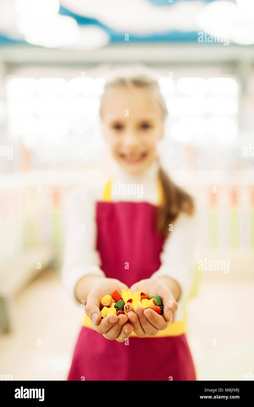 Happy little girl holds in hands handmade caramel sweets. Fresh ...