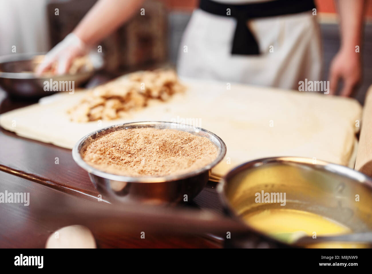 Male chef cooking apple strudel on the kitchen, pastry ingredients on ...