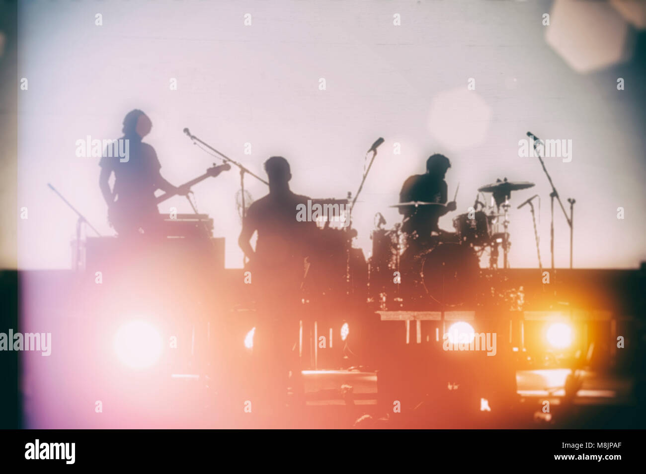 Concert of a musical rock band. Silhouettes of musicians on a set ...