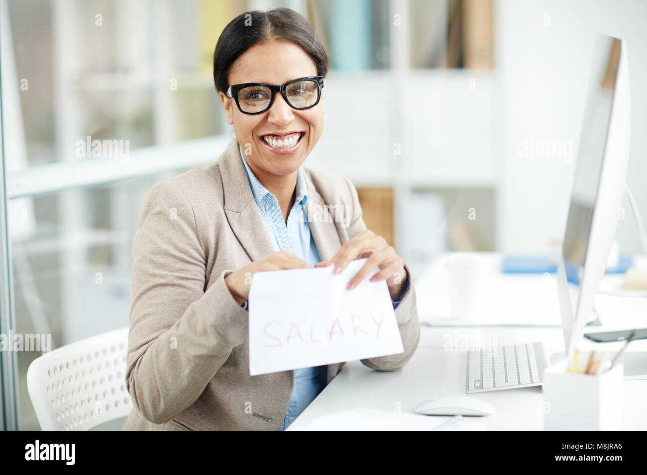 Happy businesswoman getting salary for her work Stock Photo - Alamy