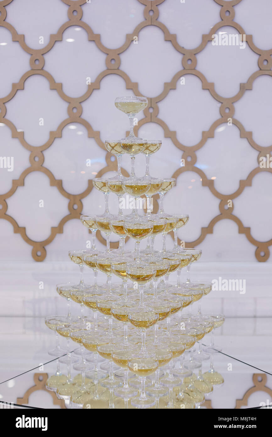 Pyramid of wine glasses with champagne on a buffet table Stock Photo ...