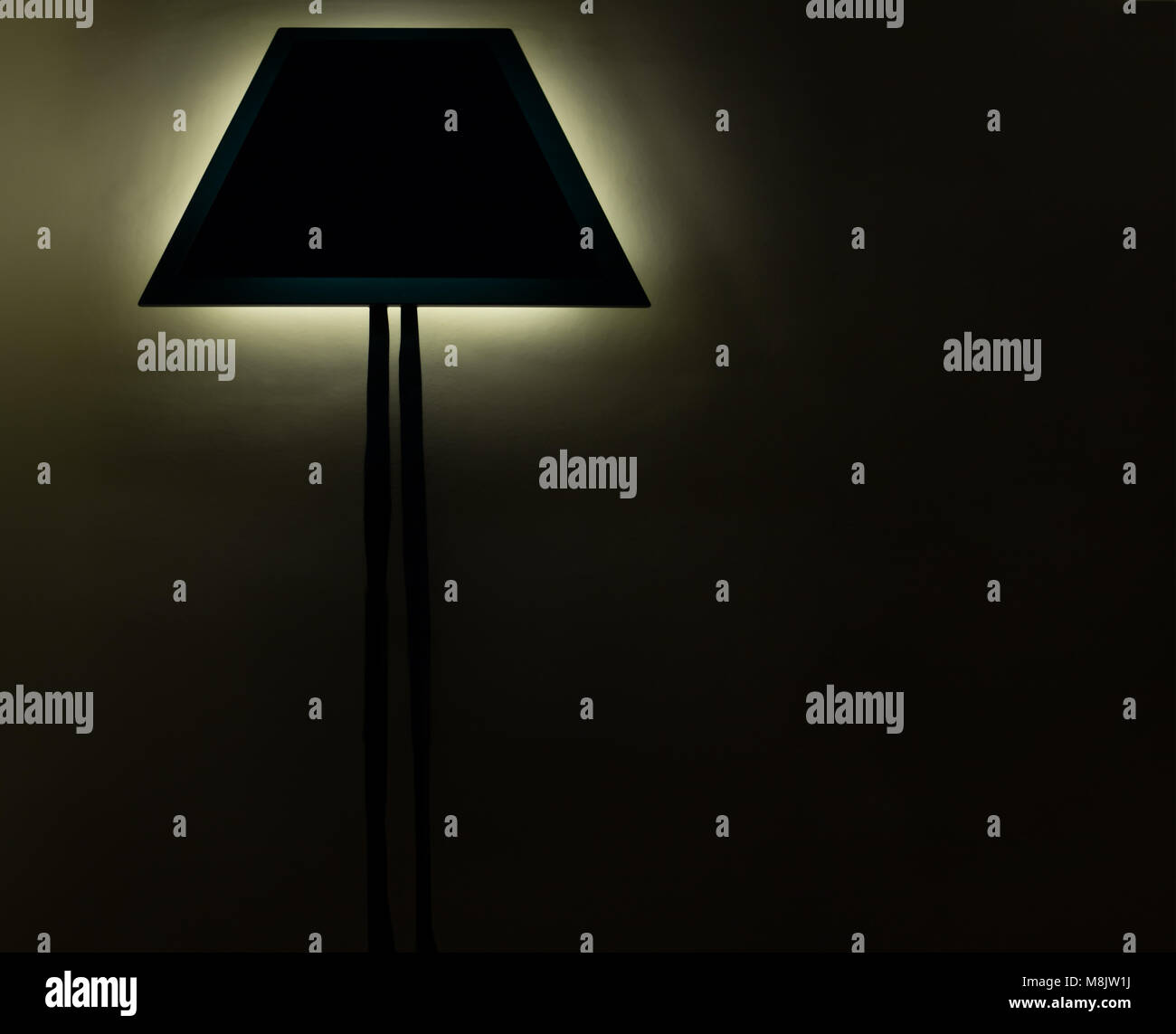 The modern sconce shines with light on the wall. The scattered light ...