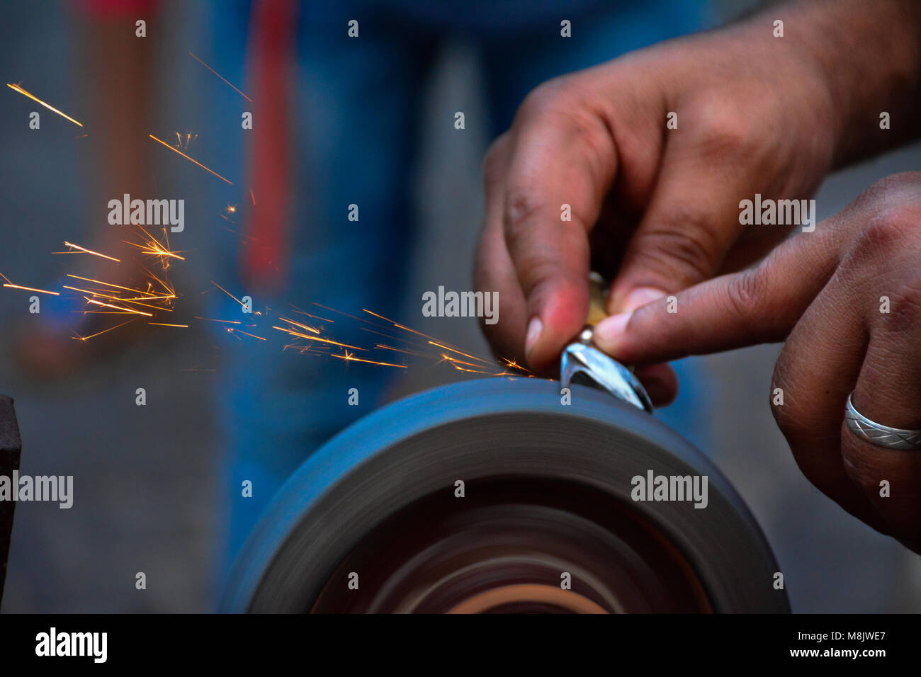knife sharpner working with sparkle Stock Photo - Alamy